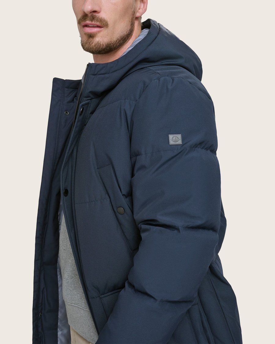 View of model wearing Navy Quilted Arctic Hooded Parka.